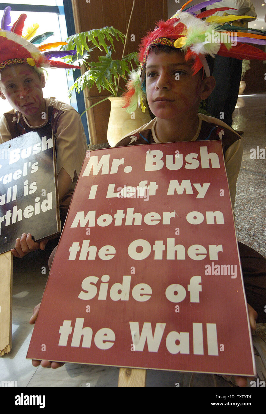 Palestinians dress as Native Americans with protest signs addressed to ...