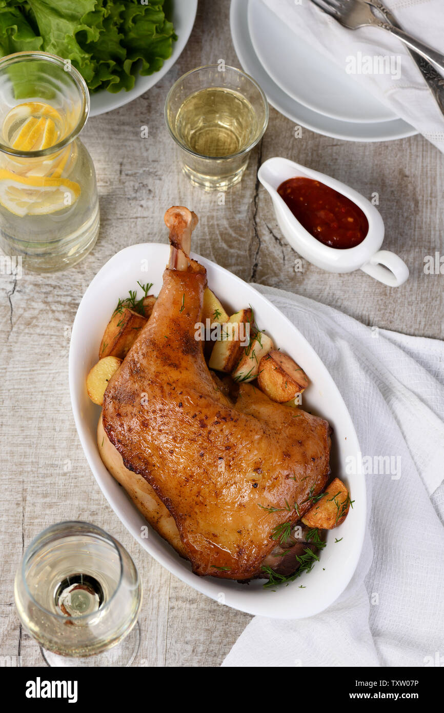 Roasted turkey leg with potatoes on the dinner table Stock Photo - Alamy