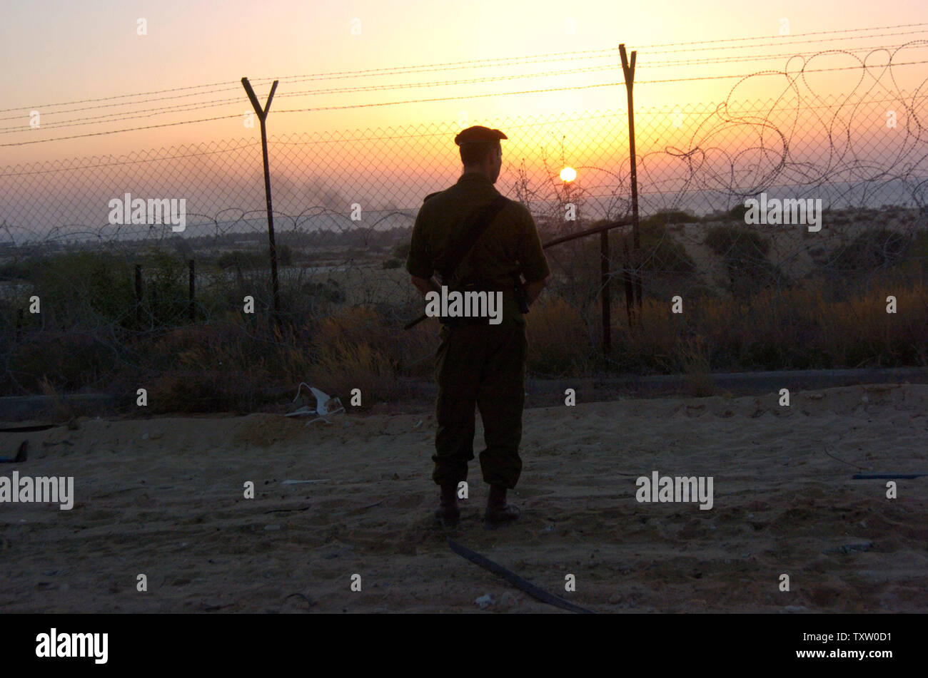 An Israeli soldier watches the sunset during the final ceremony in an ...