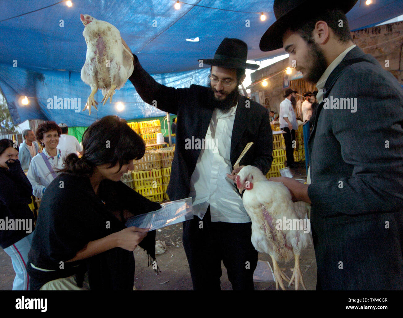 An Ultra-Orthodox Israeli swings a chicken over a woman's head while ...