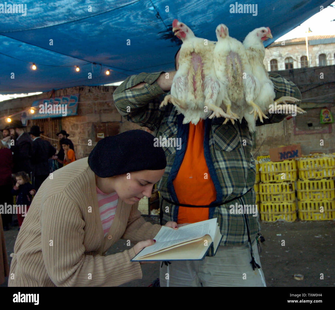 A religious Israeli swings three chickens over his pregnant wife's head ...