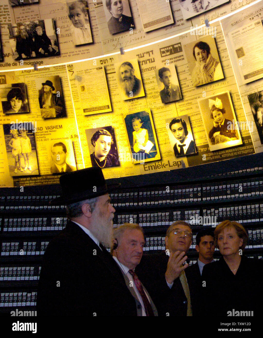 Yad Vashem Director Avner Shalev shows German Chancellor Angela Merkel ...