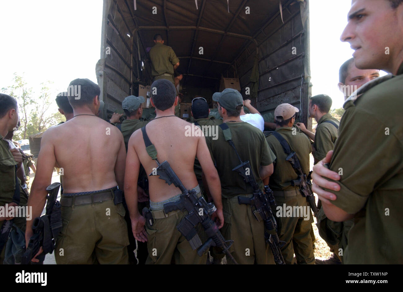 Israeli soldiers wait for supplies at a temporary camp in Kibbutz ...