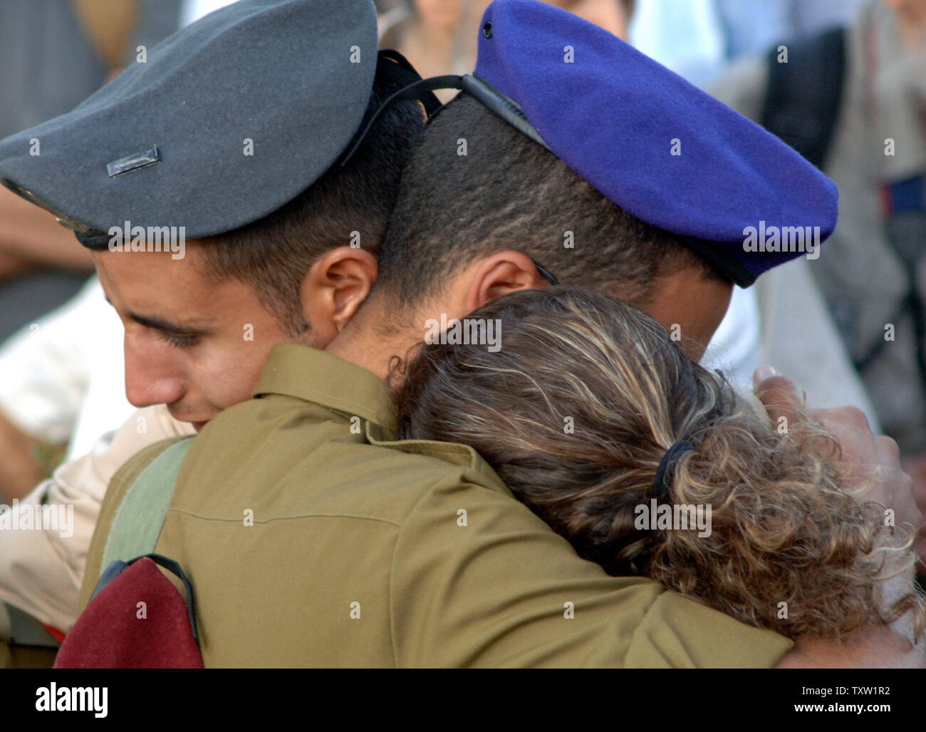 Israeli soldiers comfort each other during the funeral of their comrade ...