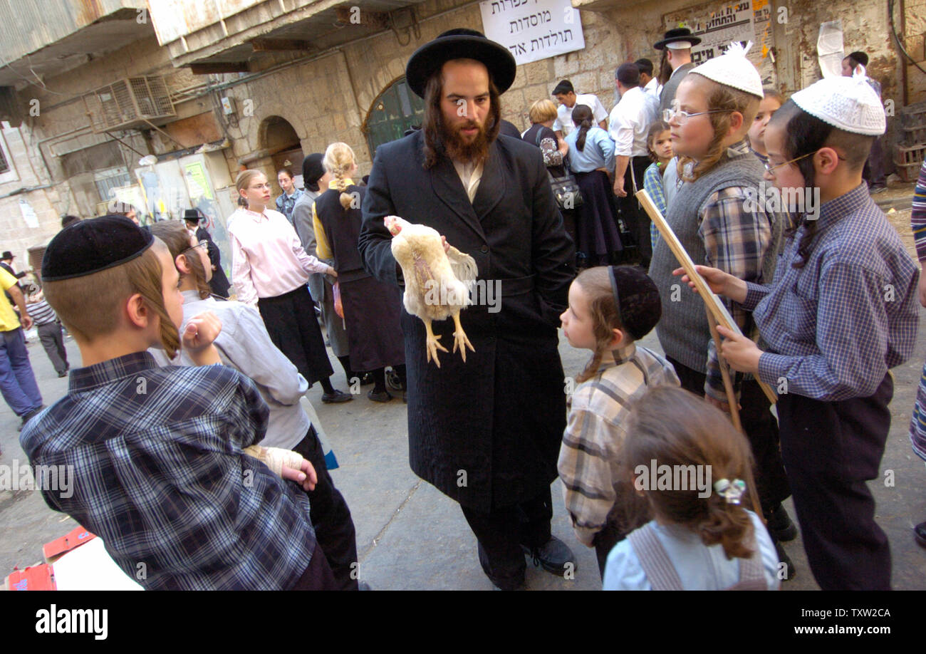 An Ultra-orthodox Israeli carries a chicken for the Kaparot ritual in ...