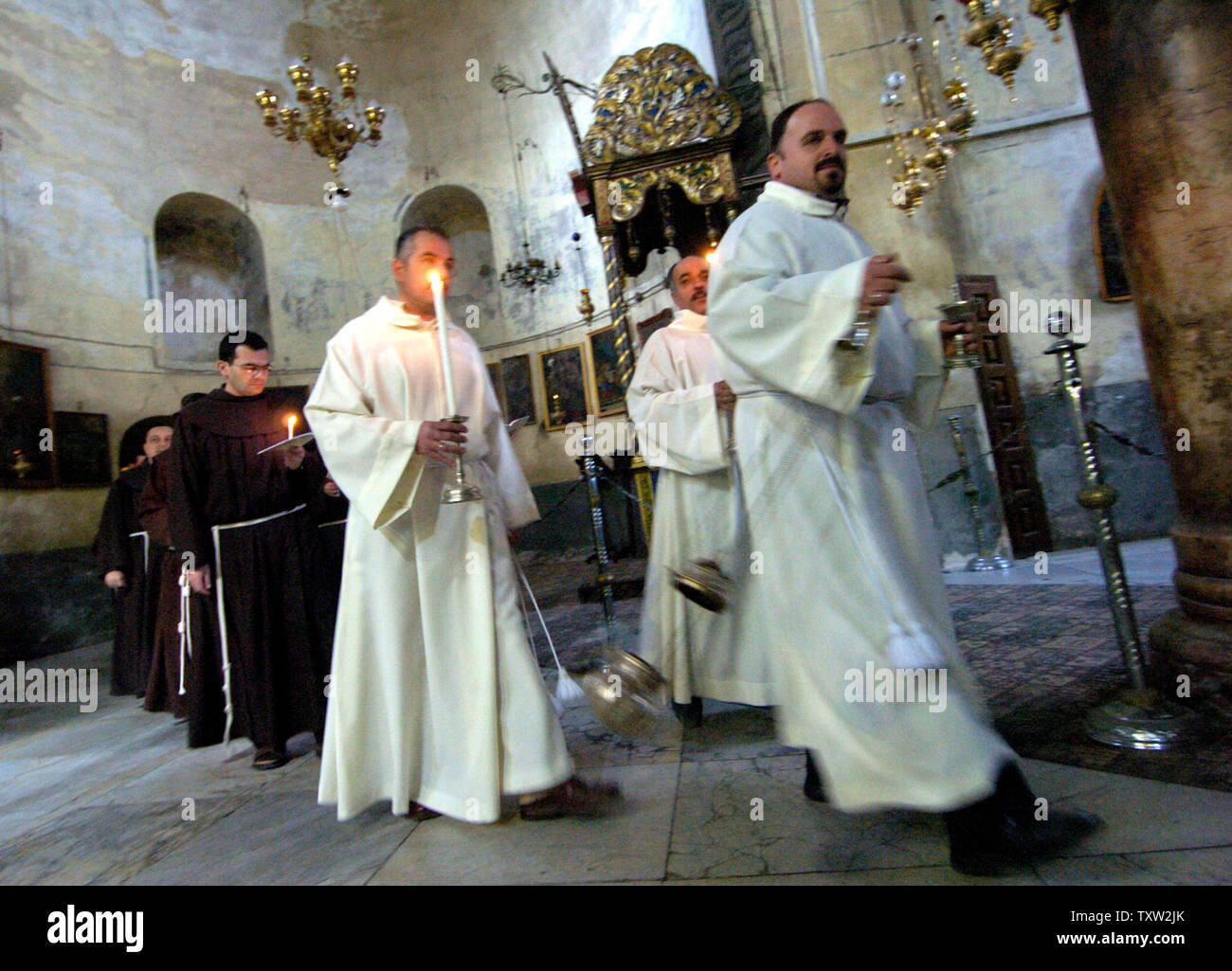 Catholic priests walk in a procession to the grotto in the Church of ...