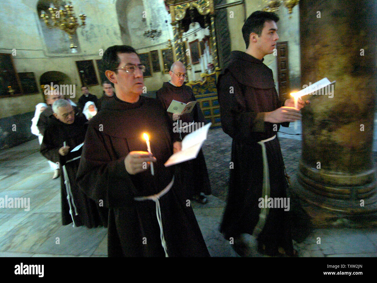 Catholic priests walk in a procession to the grotto in the Church of ...