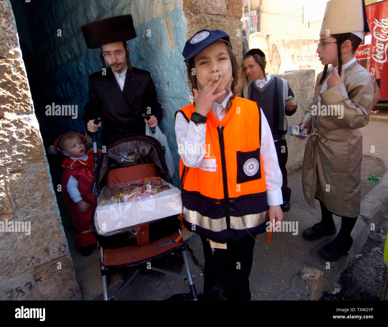 An Ultra-orthodox boy wears a costume and smokes a cigarette to ...