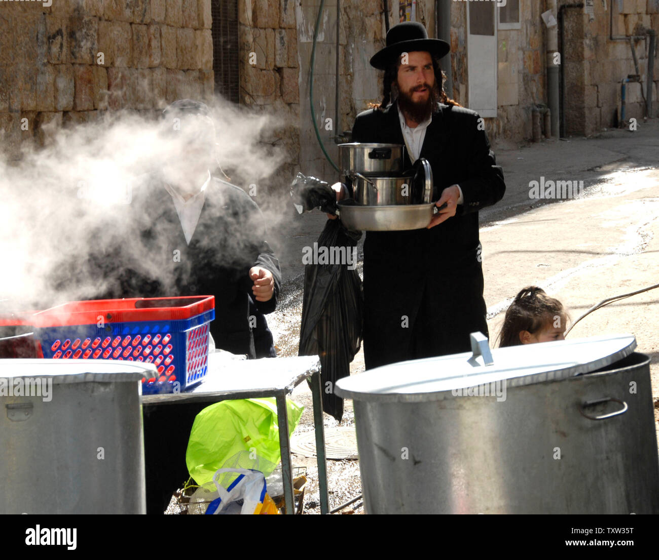 Ultra-Orthodox Israelis clean cooking utensils before the start of the ...