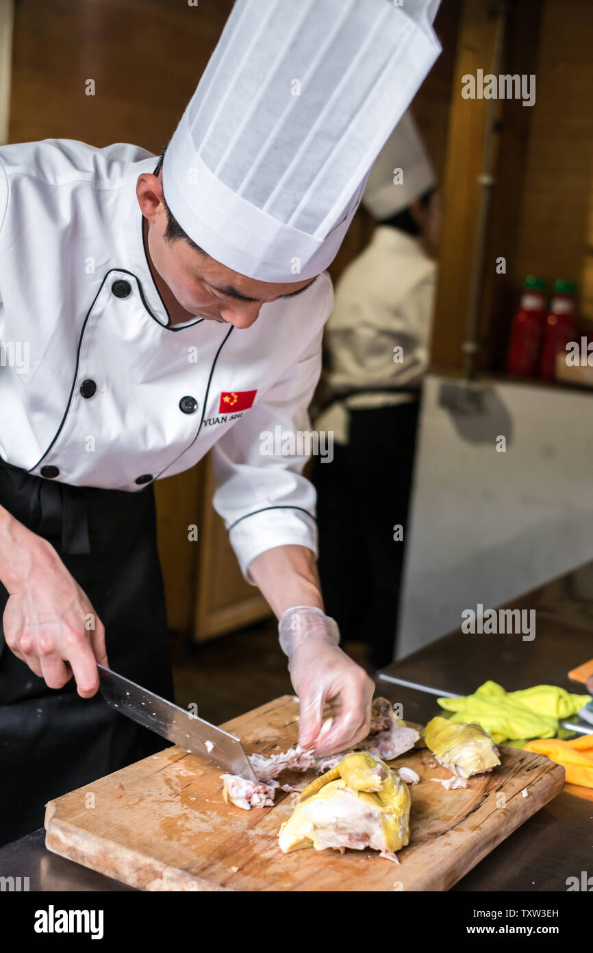 Chinese cook arranges food on plates at the premiere of Lantern ...