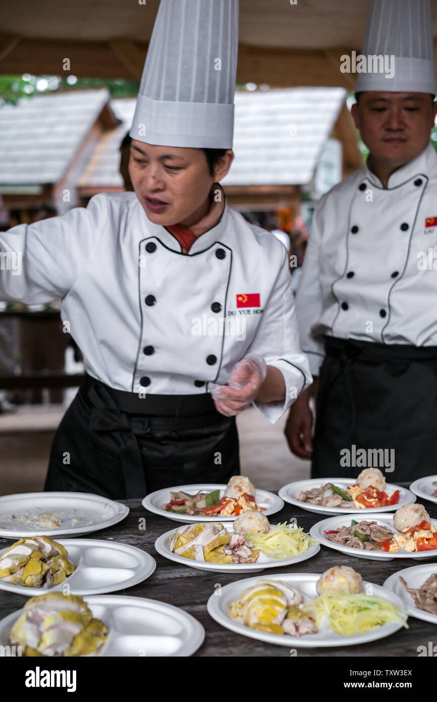 Chinese cook arranges food on plates at the premiere of Lantern ...