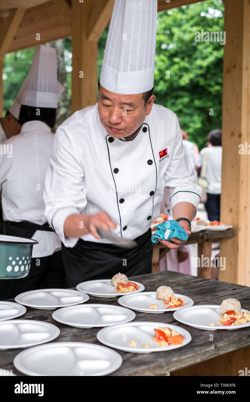 Chinese cook arranges food on plates at the premiere of Lantern ...