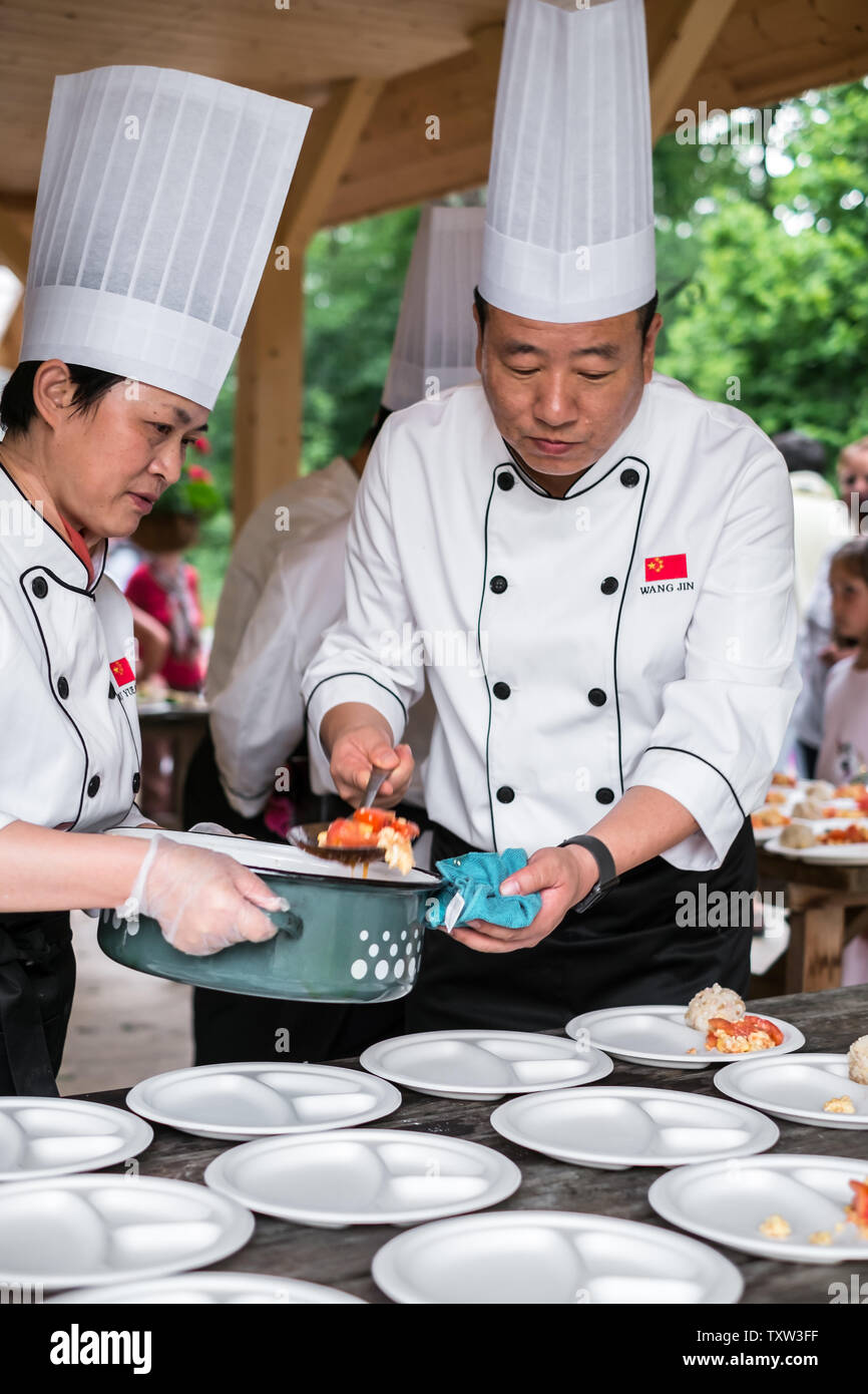 Chinese cook arranges food on plates at the premiere of Lantern ...