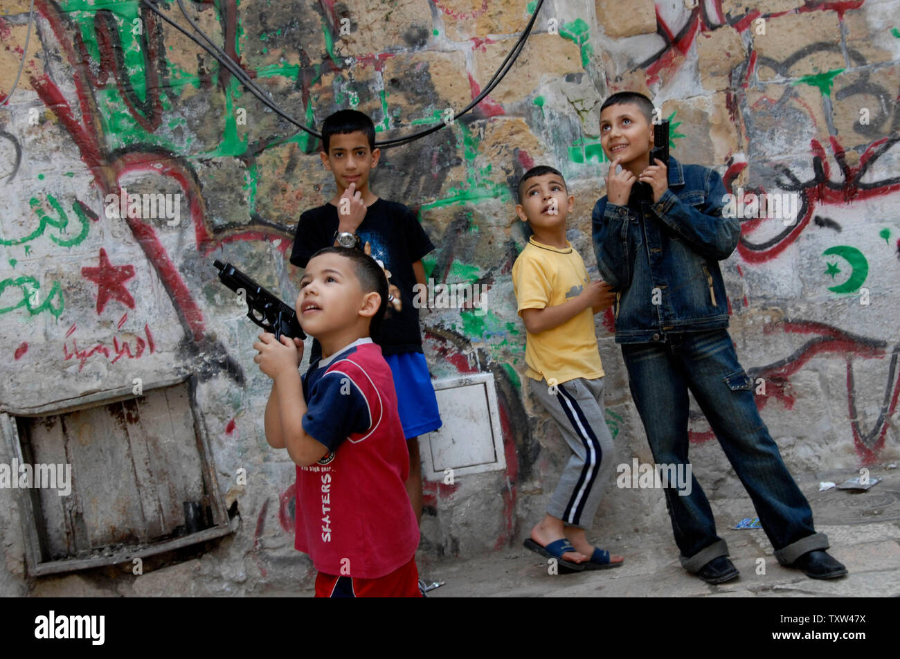 Palestinian boys play with toy guns in the Old City of Jerusalem on the ...