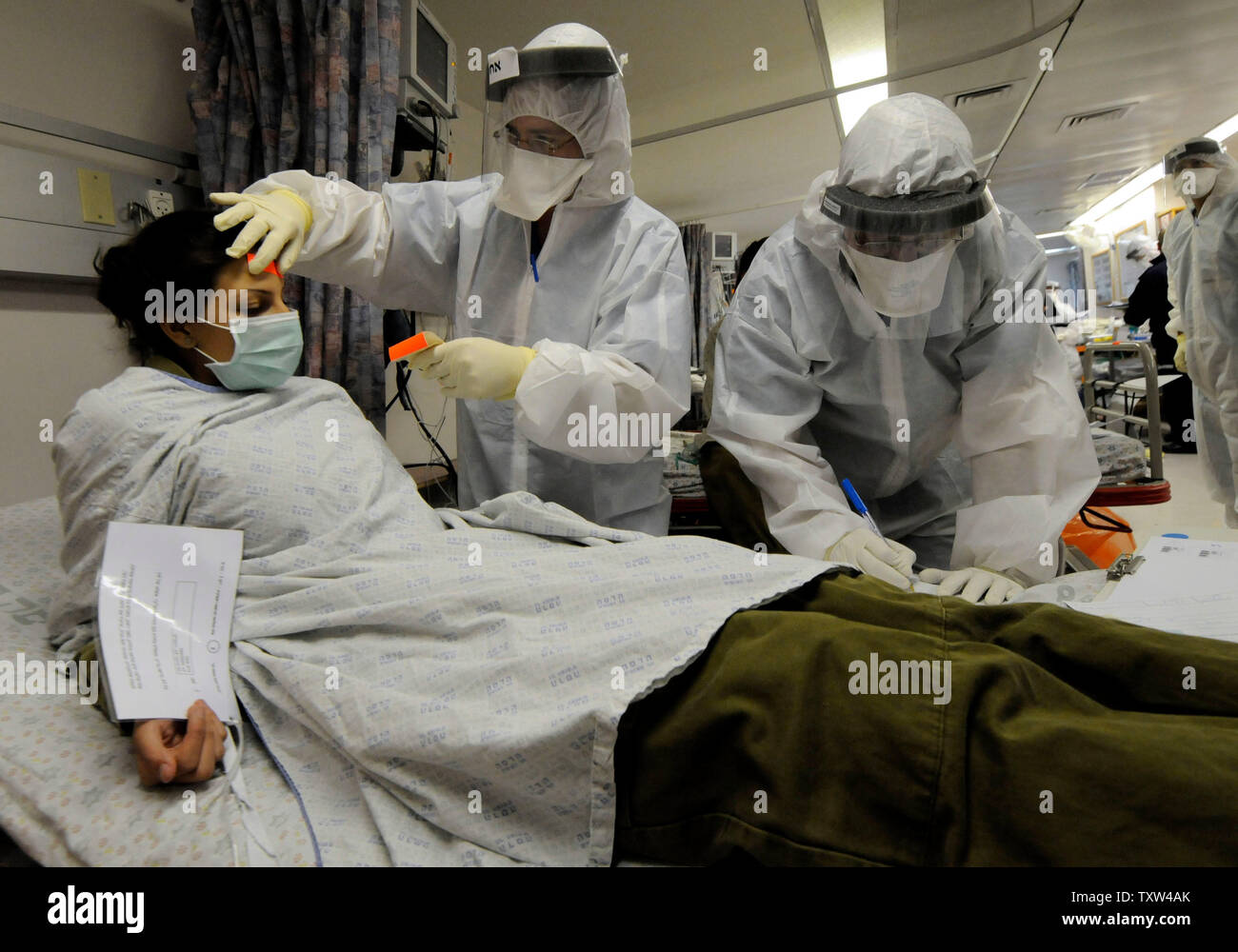 Israeli medical personnel treat a soldier for bioterror contamination ...