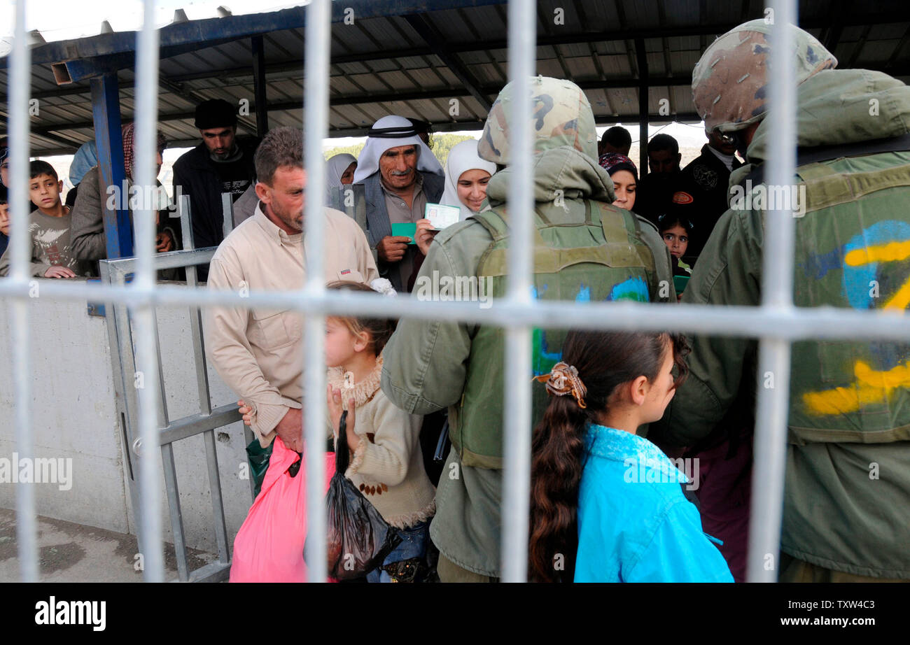 Israeli soldiers check Palestinian identity cards at the Hawara ...