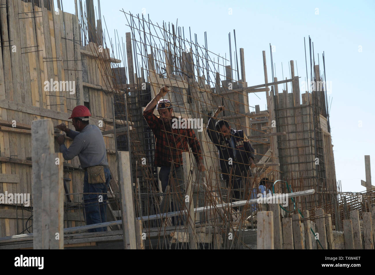 Palestinian construction workers build new apartment buildings in the ...