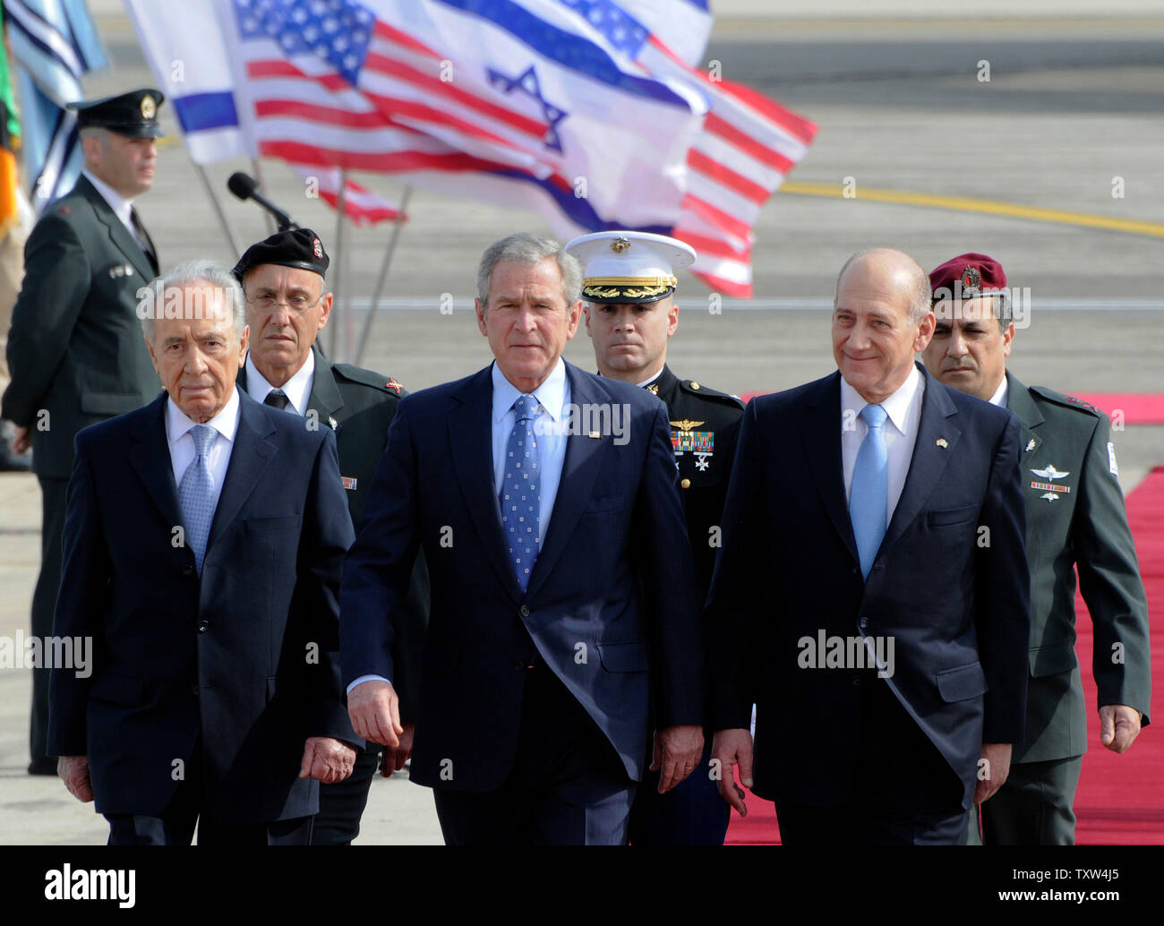 U.S. President George W. Bush, center, walks between Israeli President ...