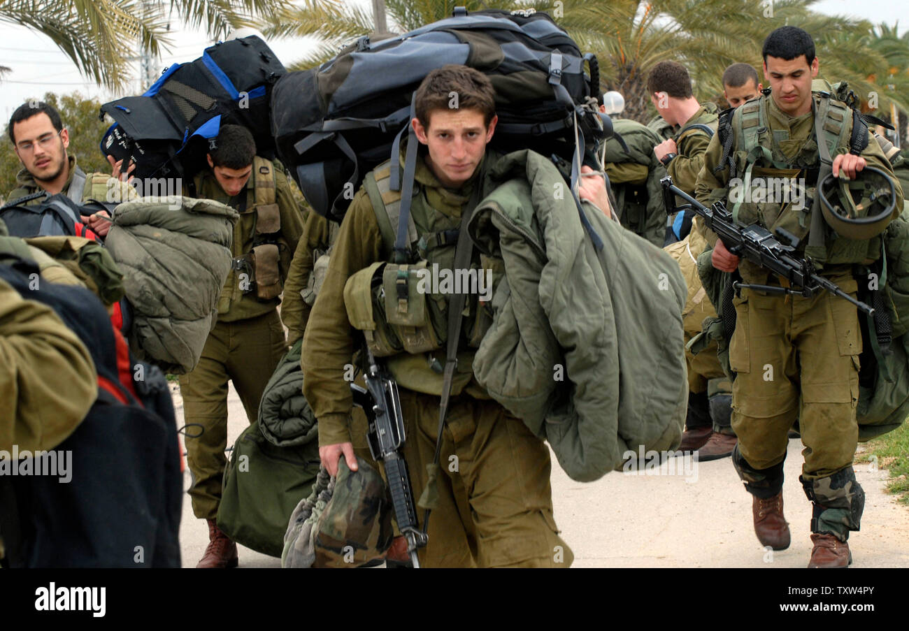 Israeli soldiers carry their gear during an operation to secure the ...