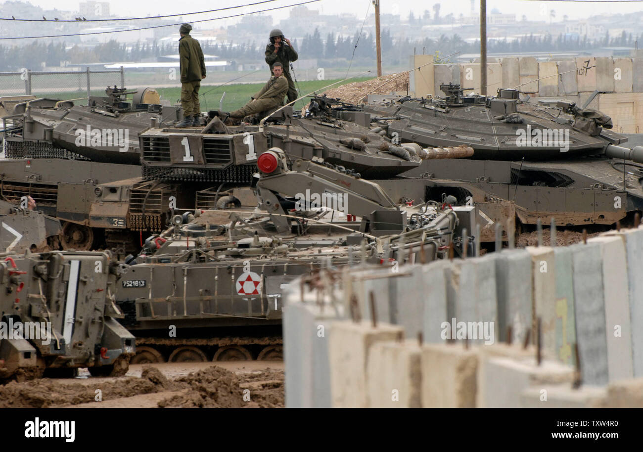 Israeli soldiers sit on tanks along the Israeli-Gaza border at Nakhal ...