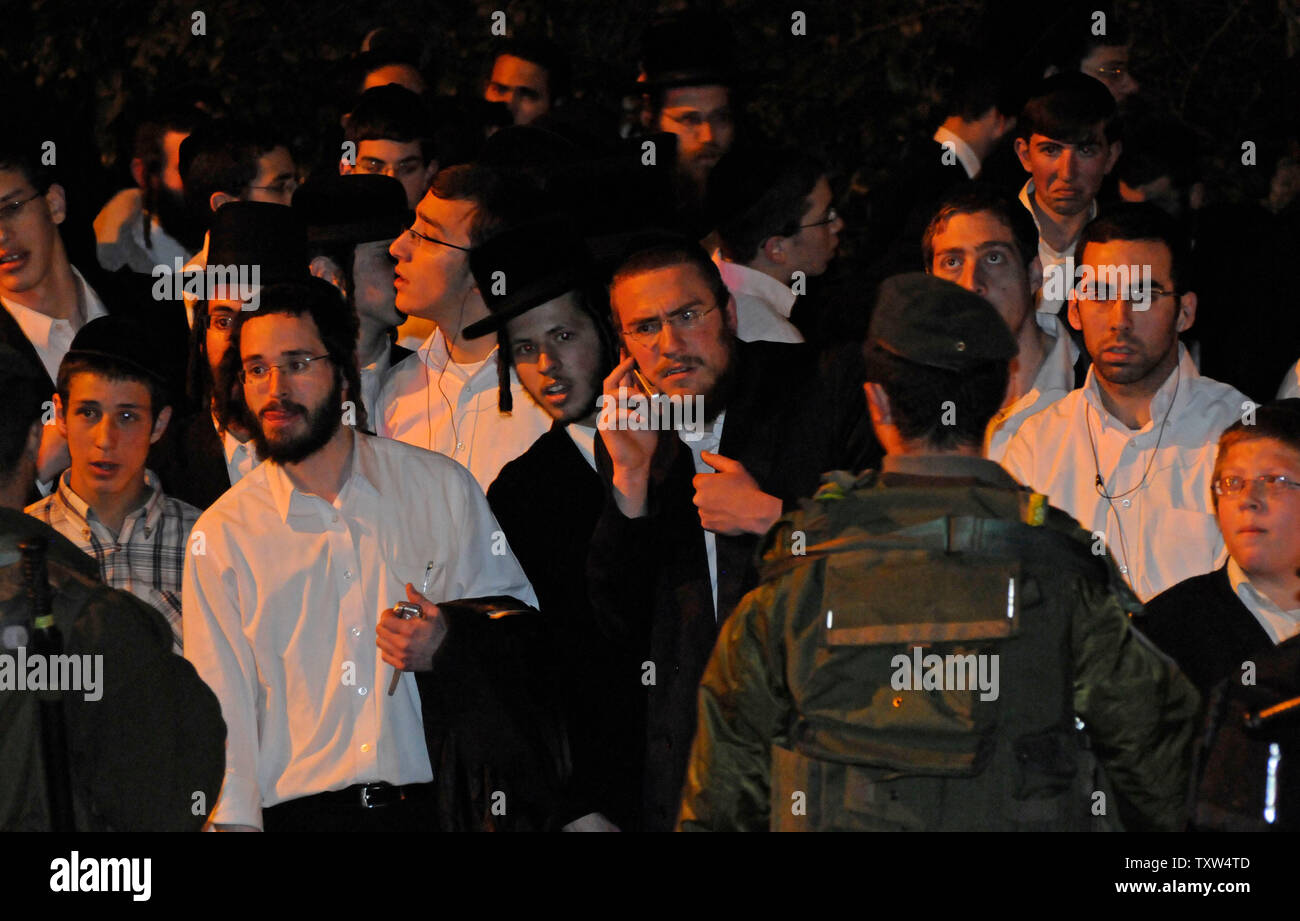 Ultra-Orthodox Jews stand outside a rabbinical seminary where a ...