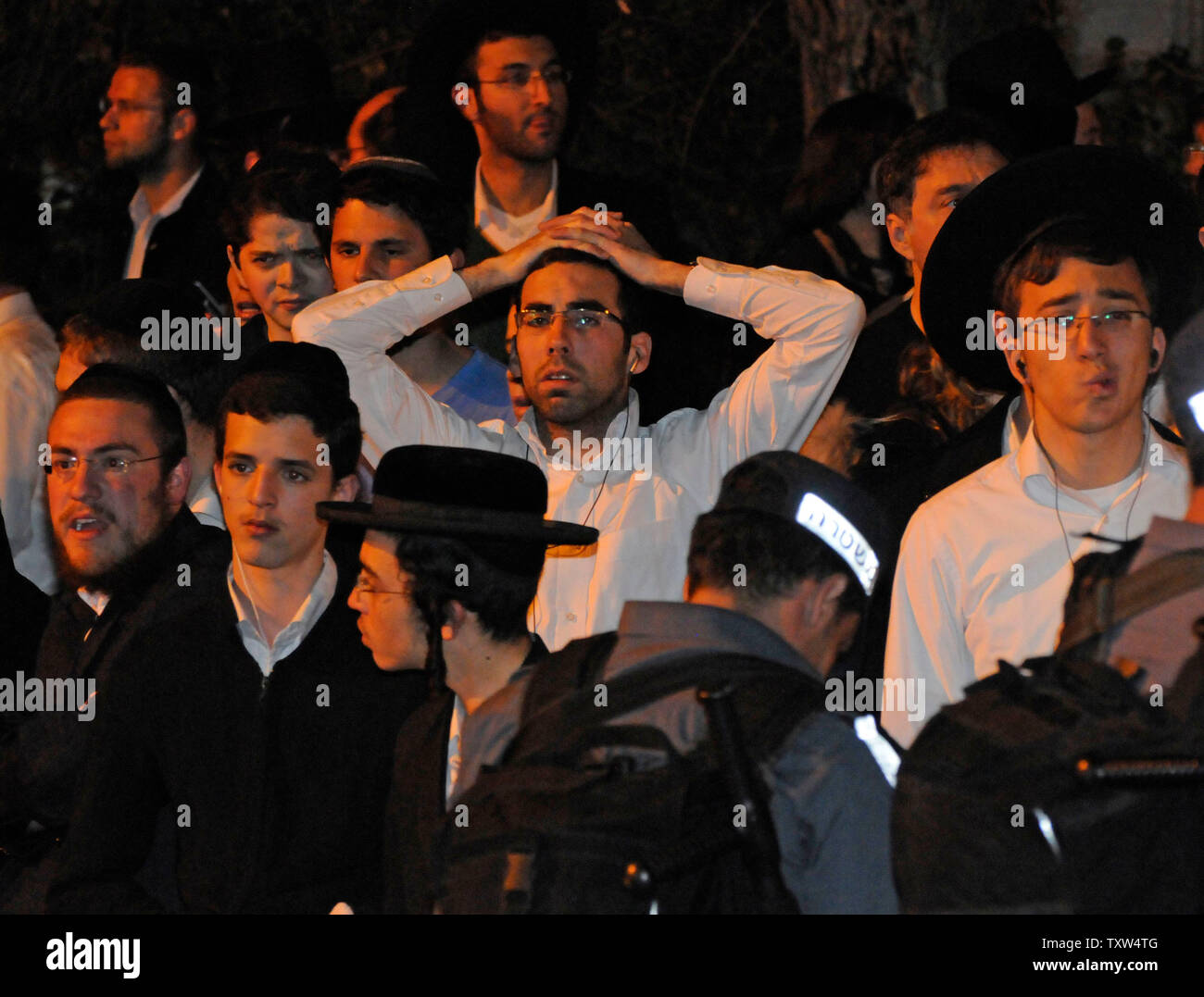 Ultra-Orthodox Jews stand outside a rabbinical seminary where a ...