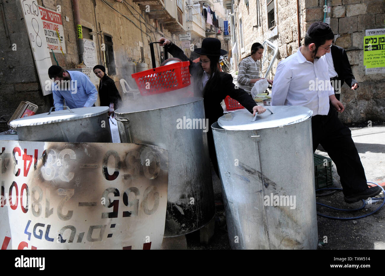 Ultra-Orthodox Israelis dip cooking utensils into boiling water to ...