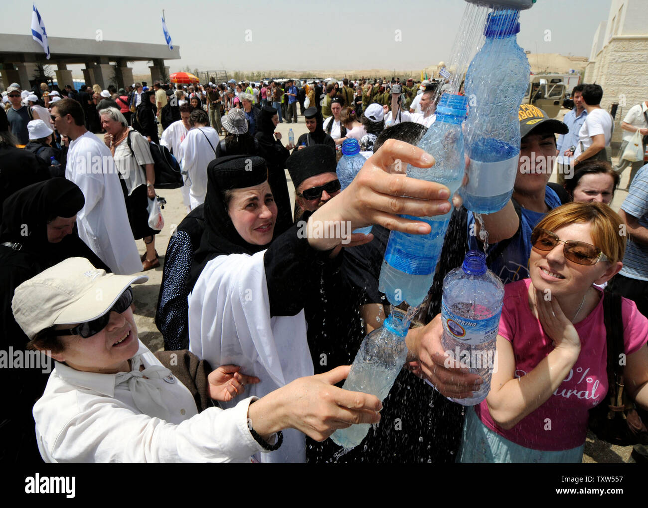 Orthodox Christian fill water bottles with water from the Jordan River ...