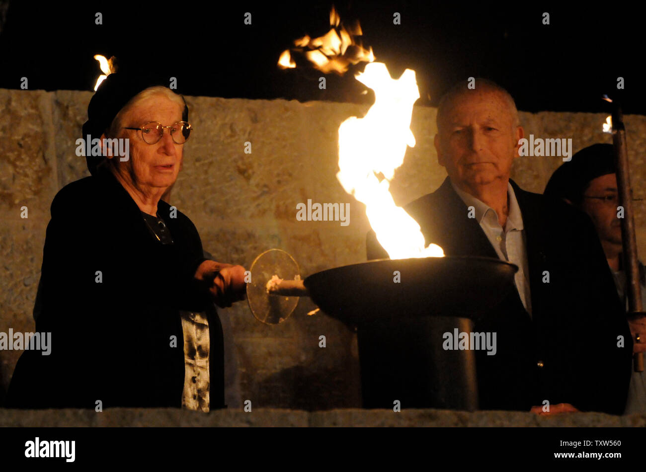 Holocaust survivor Ester Samuel-Cahn lights a torch at the opening ...