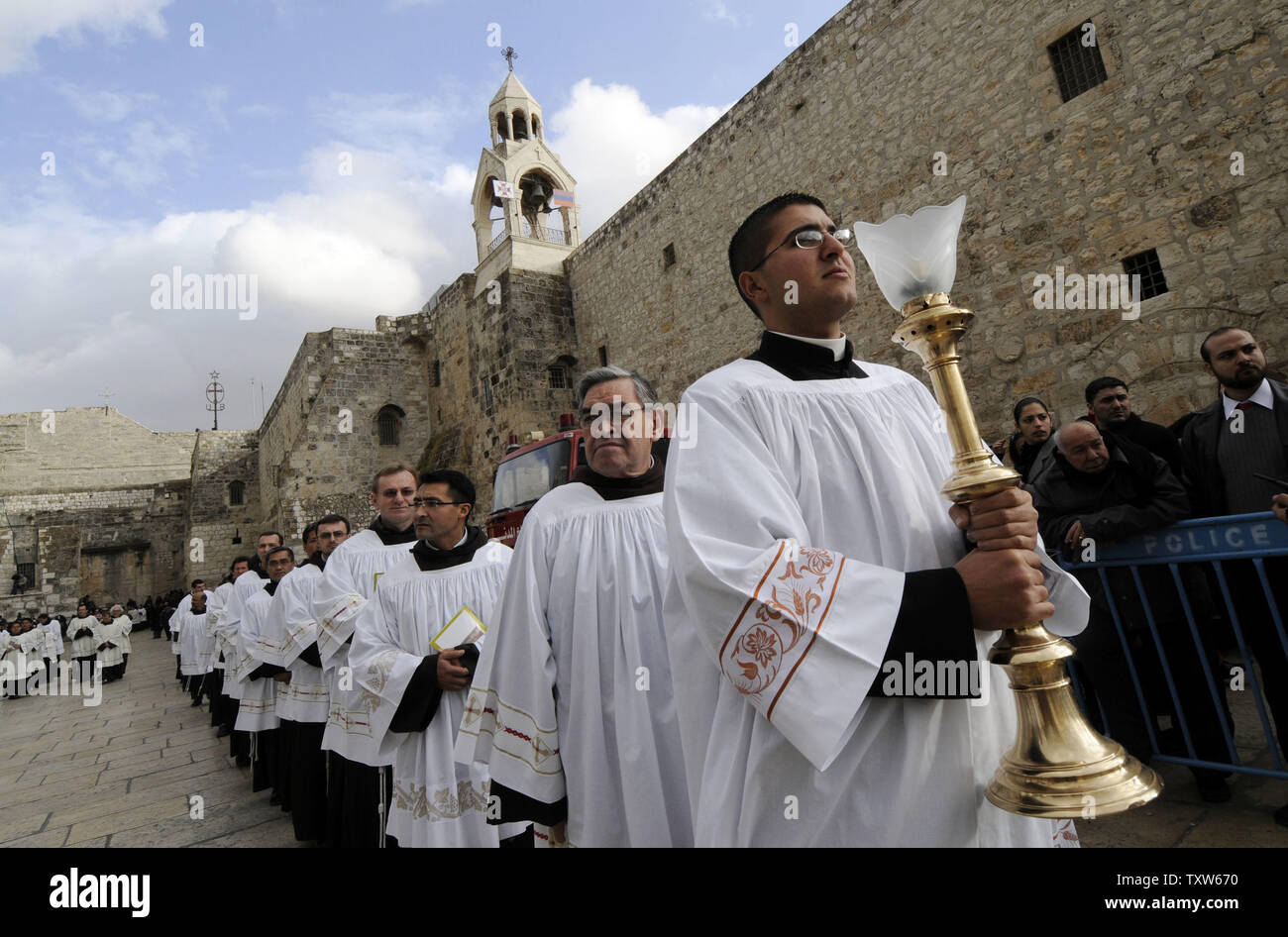 Catholic priests walk in a procession outside the Church of Nativity on ...