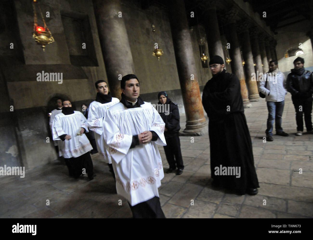 Catholic priests walk in a procession in the Church of Nativity on ...