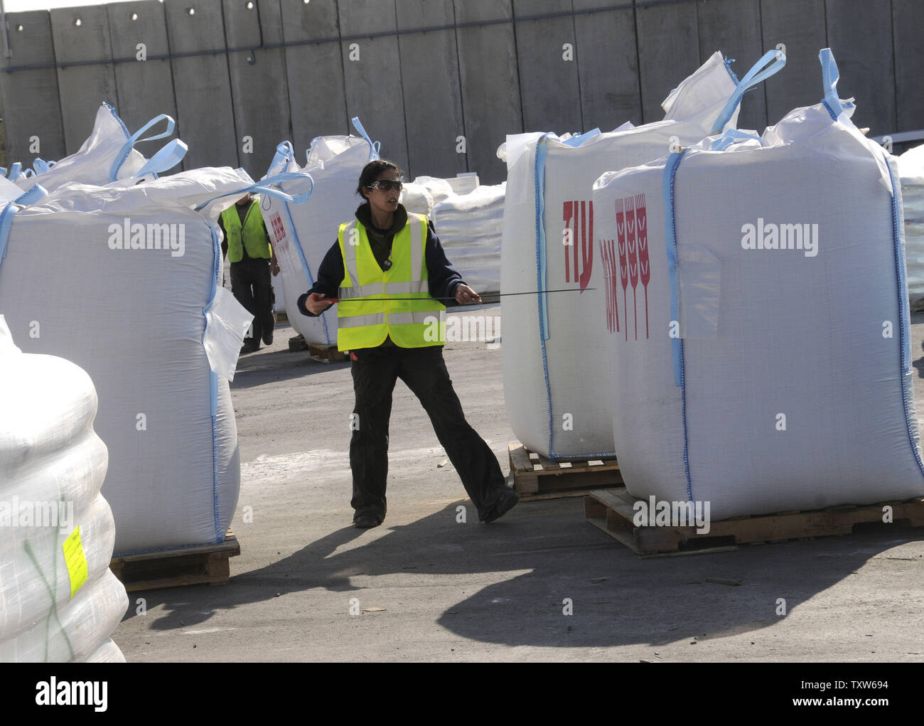 An Israeli soldier checks humanitarian aid at the Kerem Shalom crossing ...