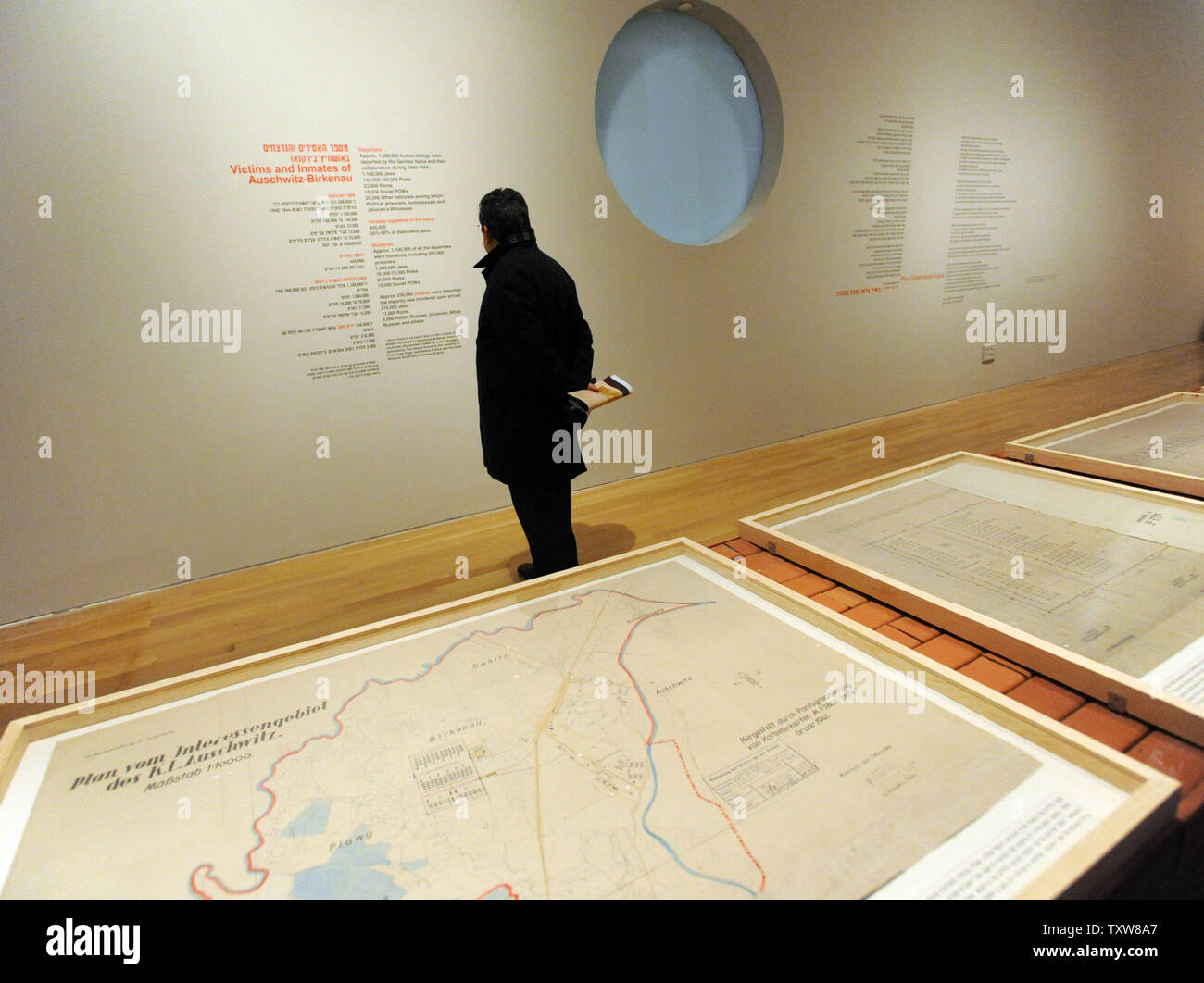 A journalist reads about original blueprints of the Auschwitz-Birkenau ...
