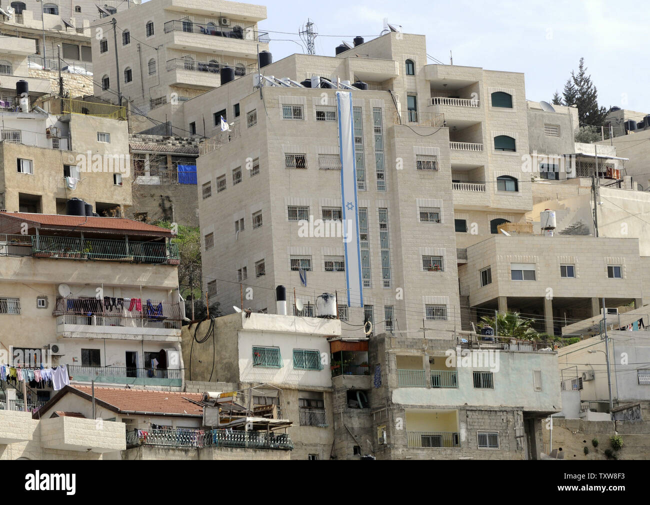A large Israeli flag hangs on Beit Yonatan, a house built by Jewish ...