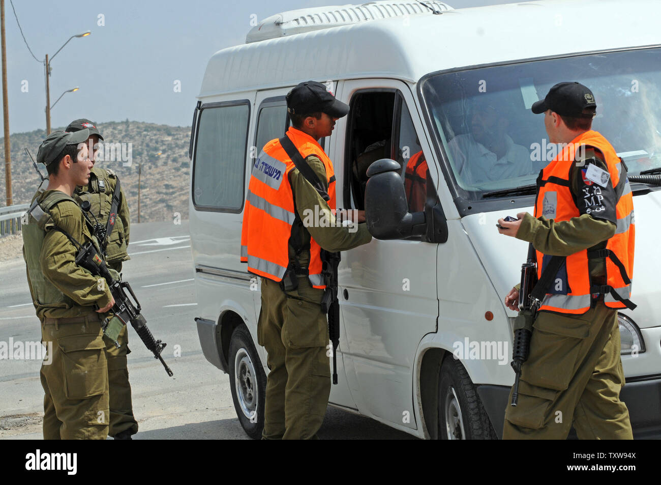 Israeli soldiers inspect a Palestinian car at the new Beit Ur al Fauqa ...
