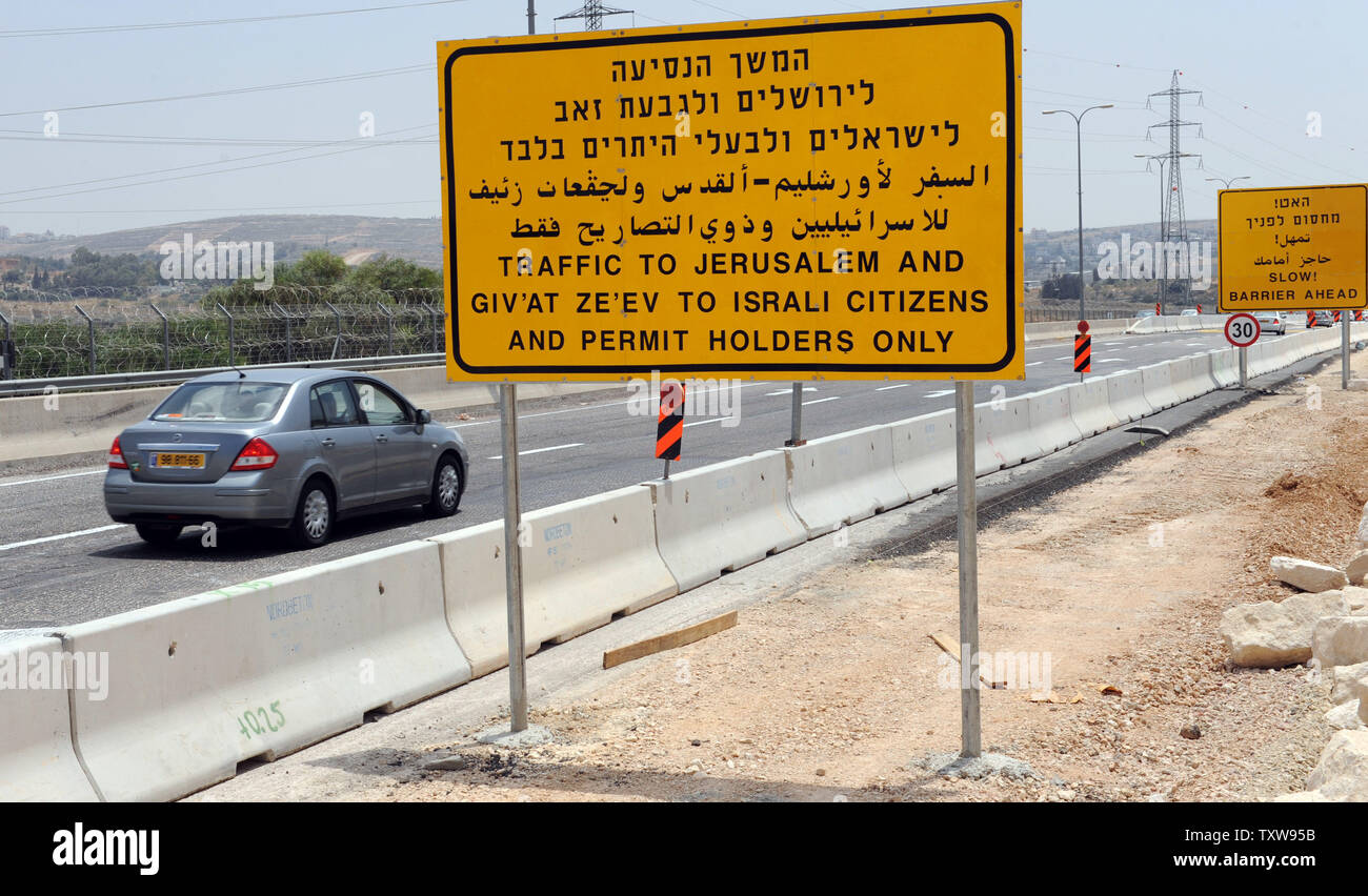 An Israeli road sign cautions drivers to stop at a new military ...