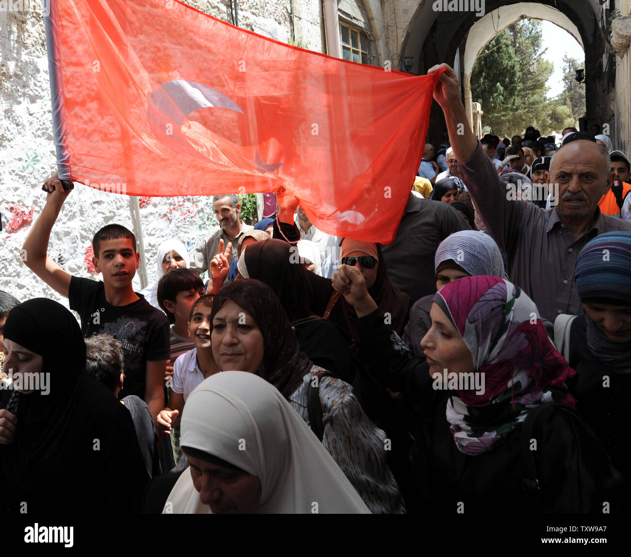Palestinians carry a Turkish flag after Friday prayers in the Old City ...