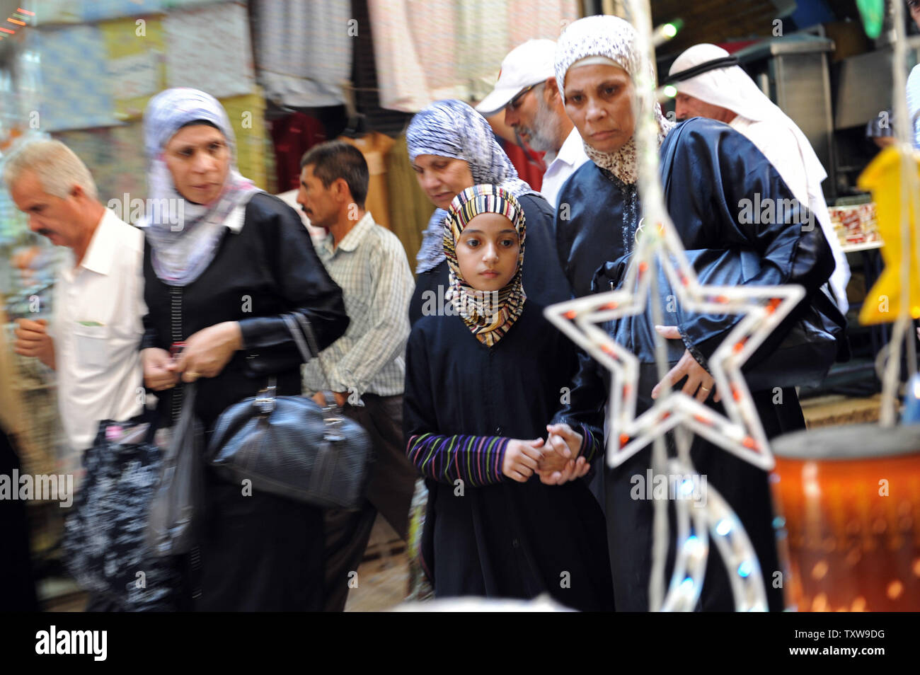 A Palestinian girl looks at Ramadan decorations in the Old City of ...