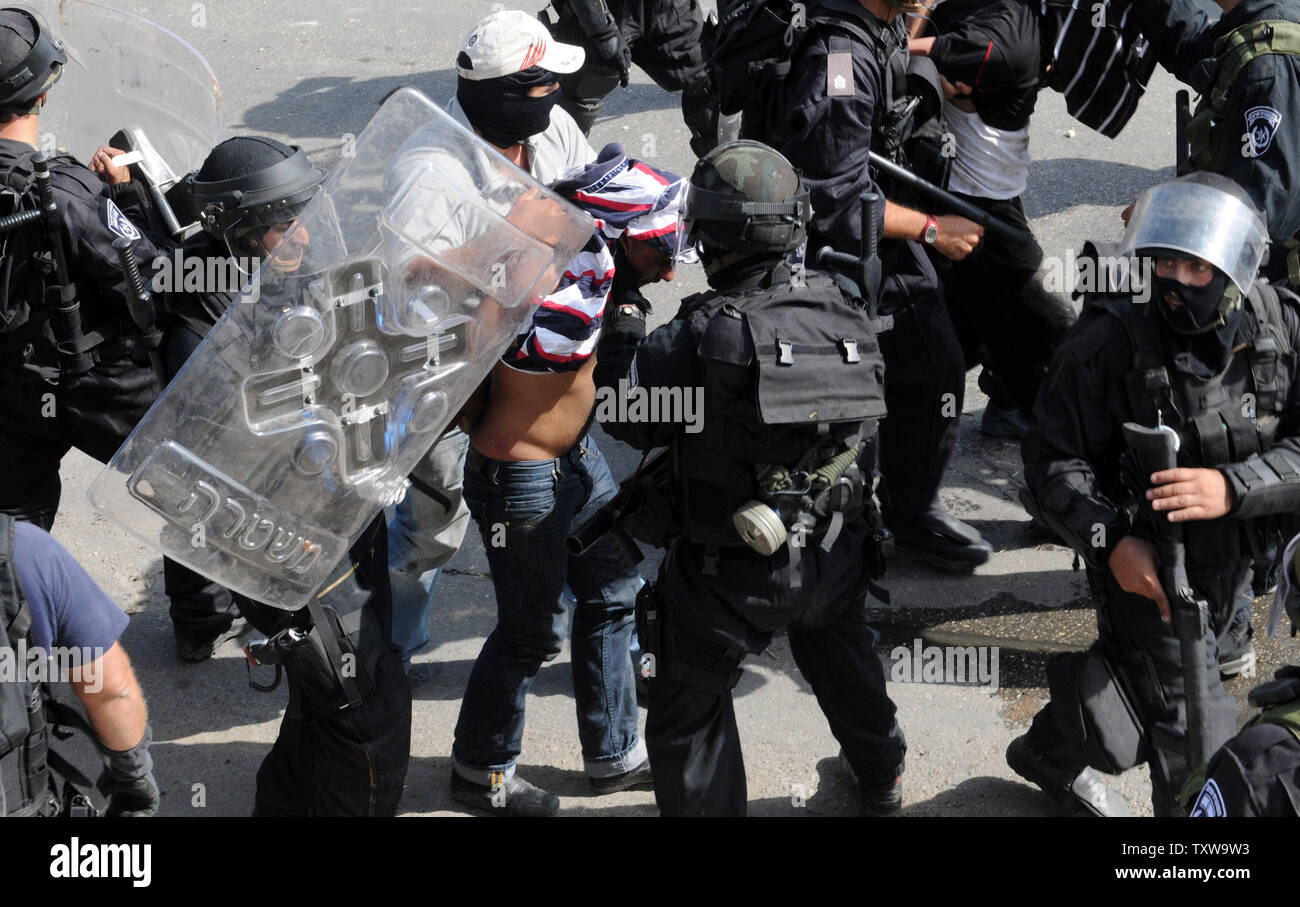 Israeli riot police arrest a rock throwing Arab Israeli during clashes ...