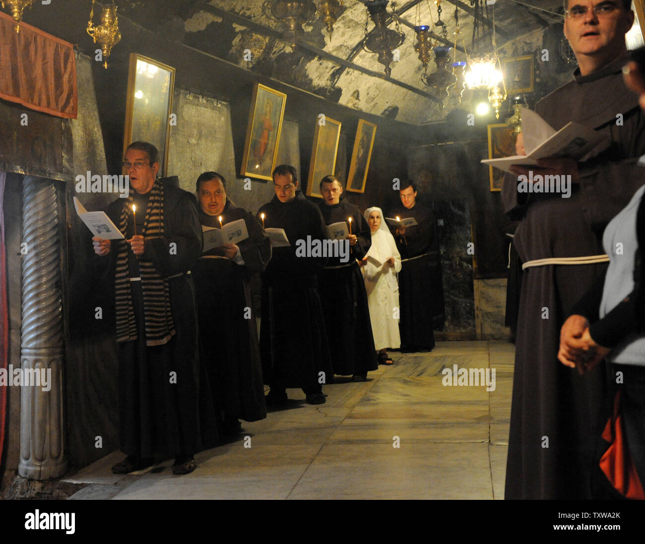 Franciscan brothers pray in the grotto of the Church of the Nativity ...
