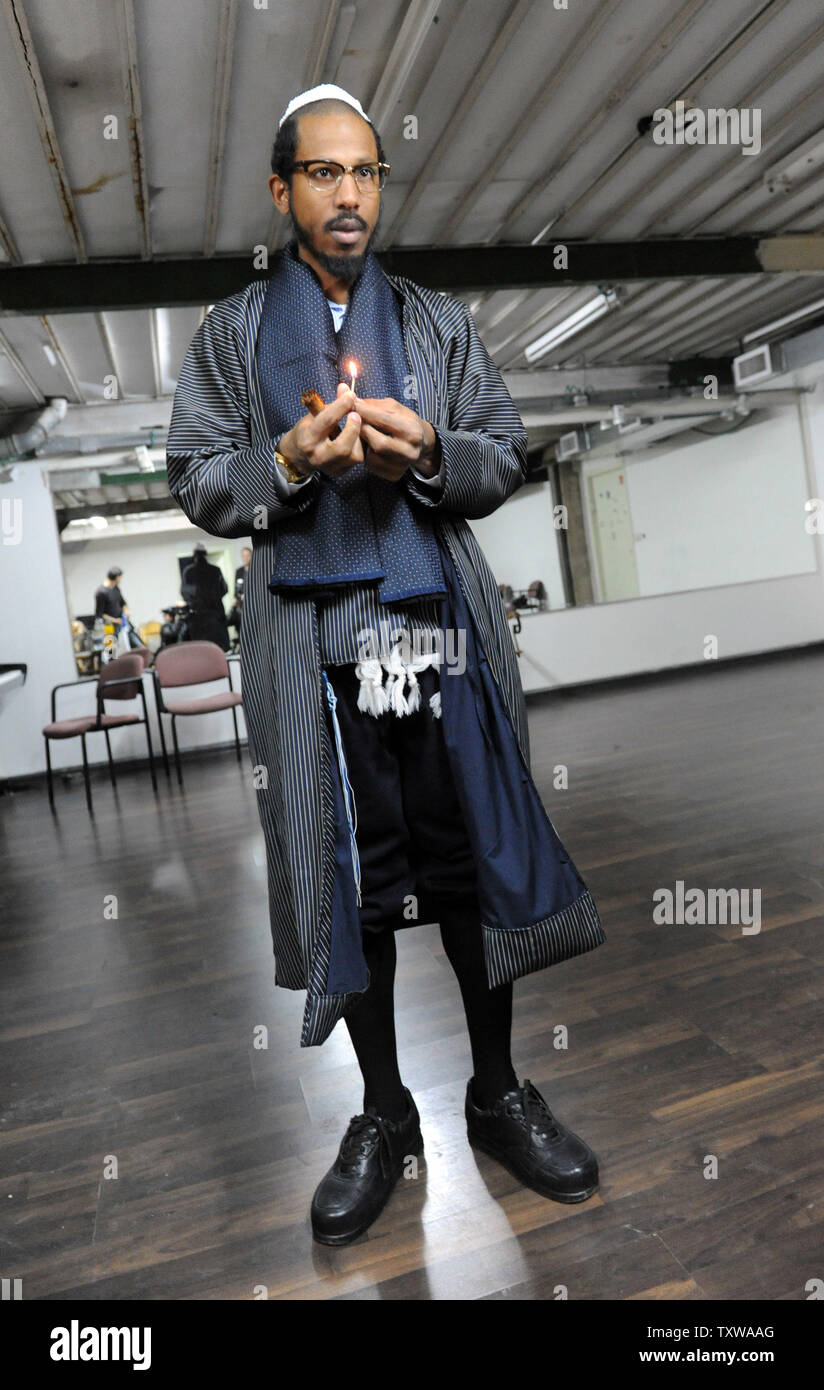 The rapper Shyne lights a cigar before the world premiere of his short ...