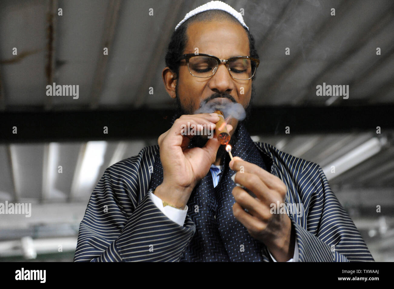 The rapper Shyne lights a cigar before the world premiere of his short ...