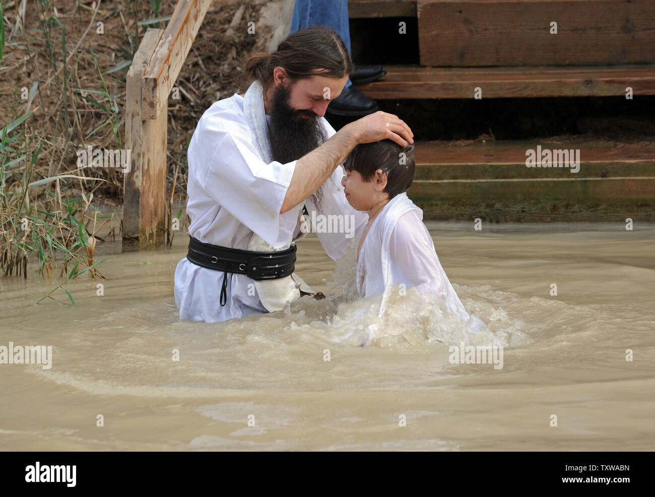 An Orthodox Christian priest baptises a boy as Orthodox Christians mark ...