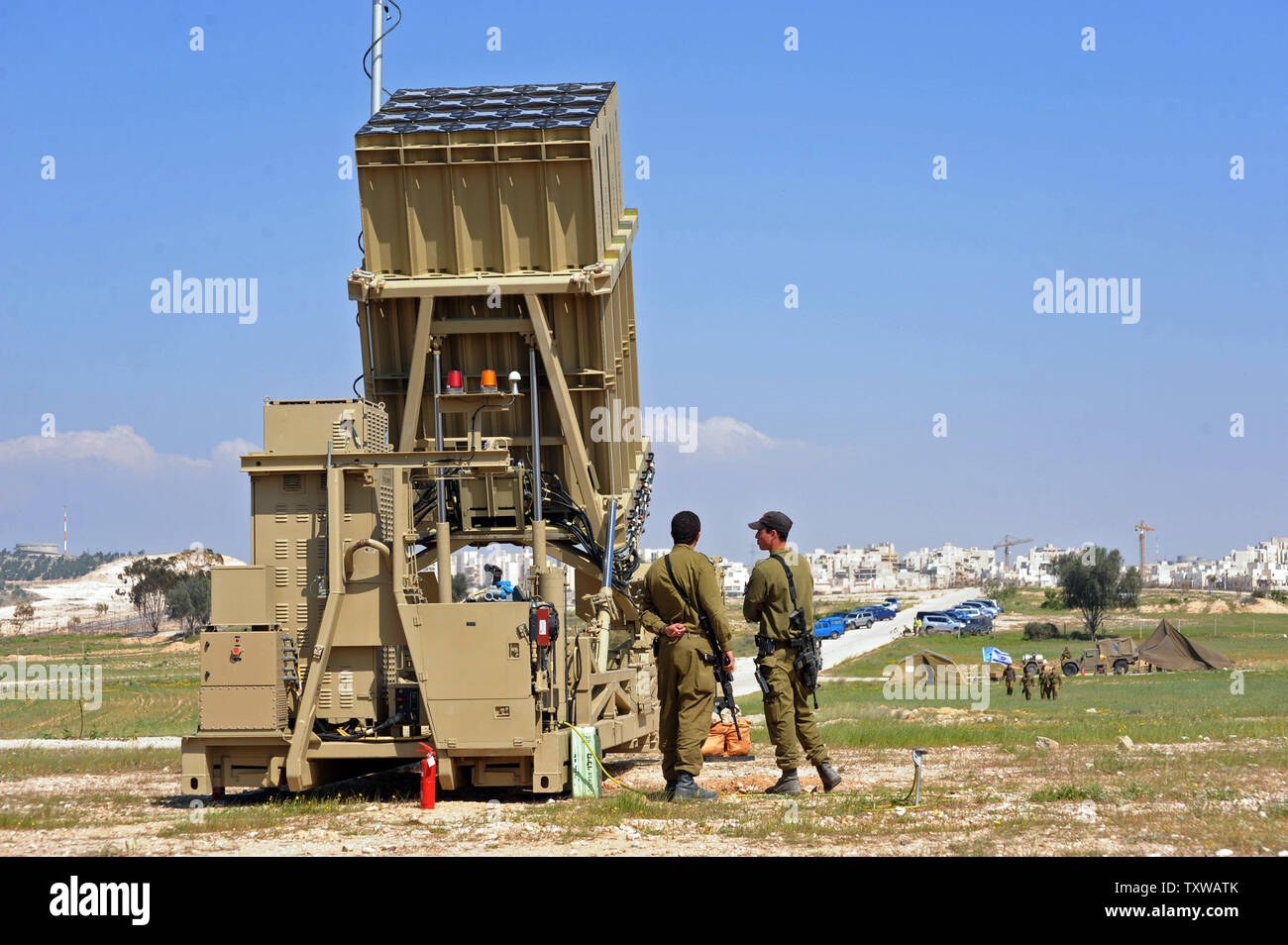 Israeli soldiers stand near the Iron Dome, a new anti-rocket system ...