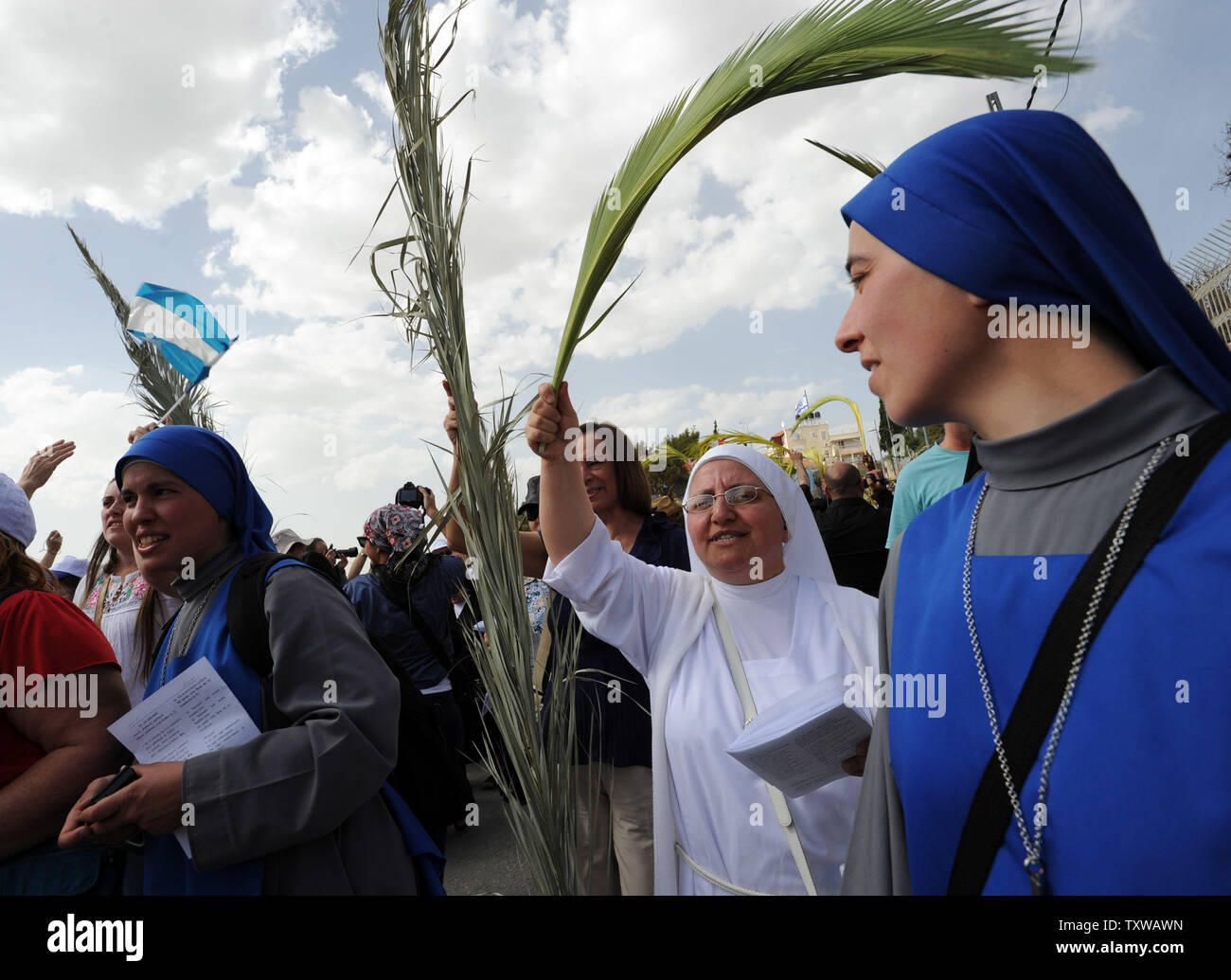 Nuns wave palm branches during the Palm Sunday procession on the Mount ...