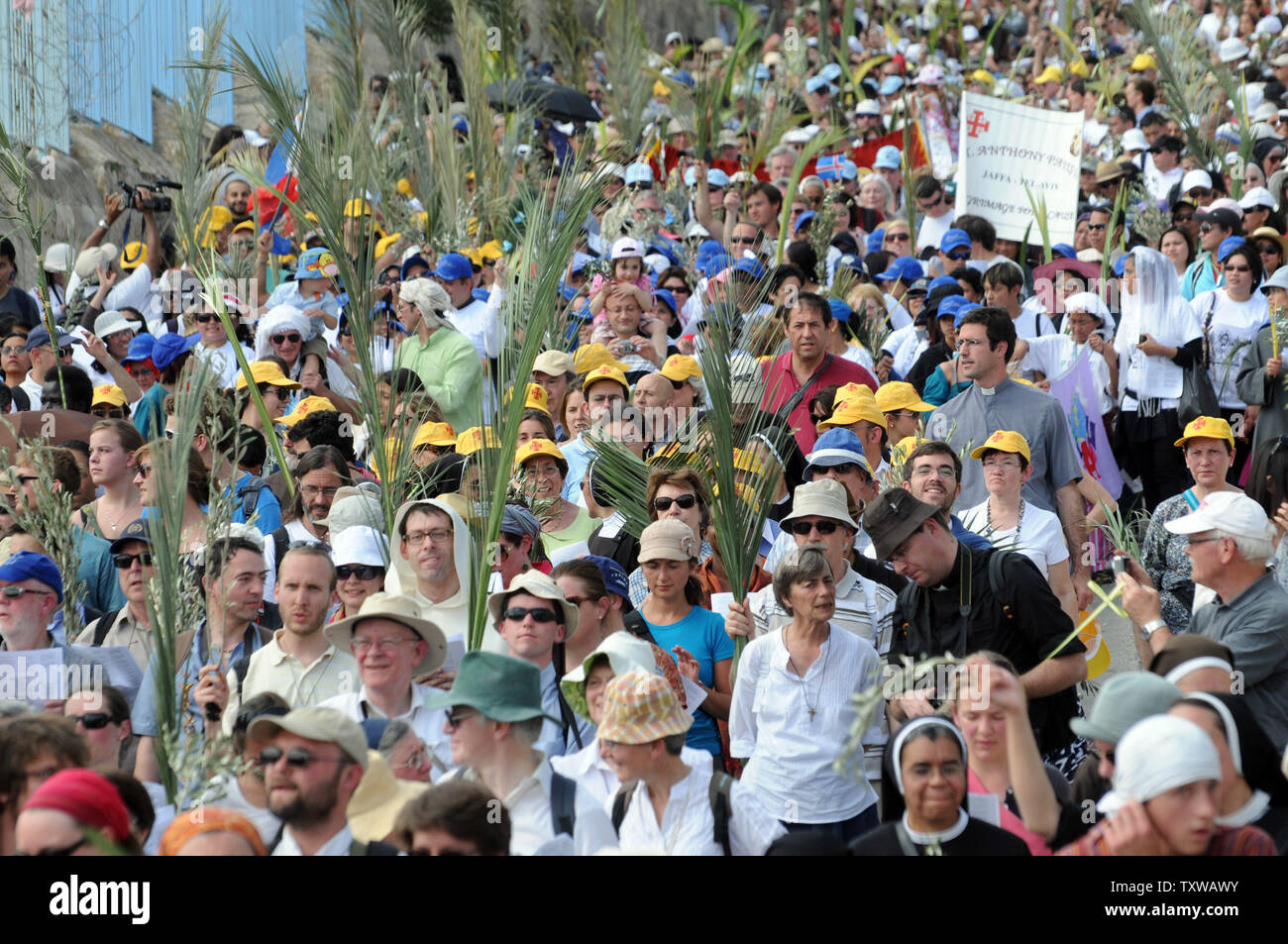 Christian pilgrims carry palm branches during the Palm Sunday ...