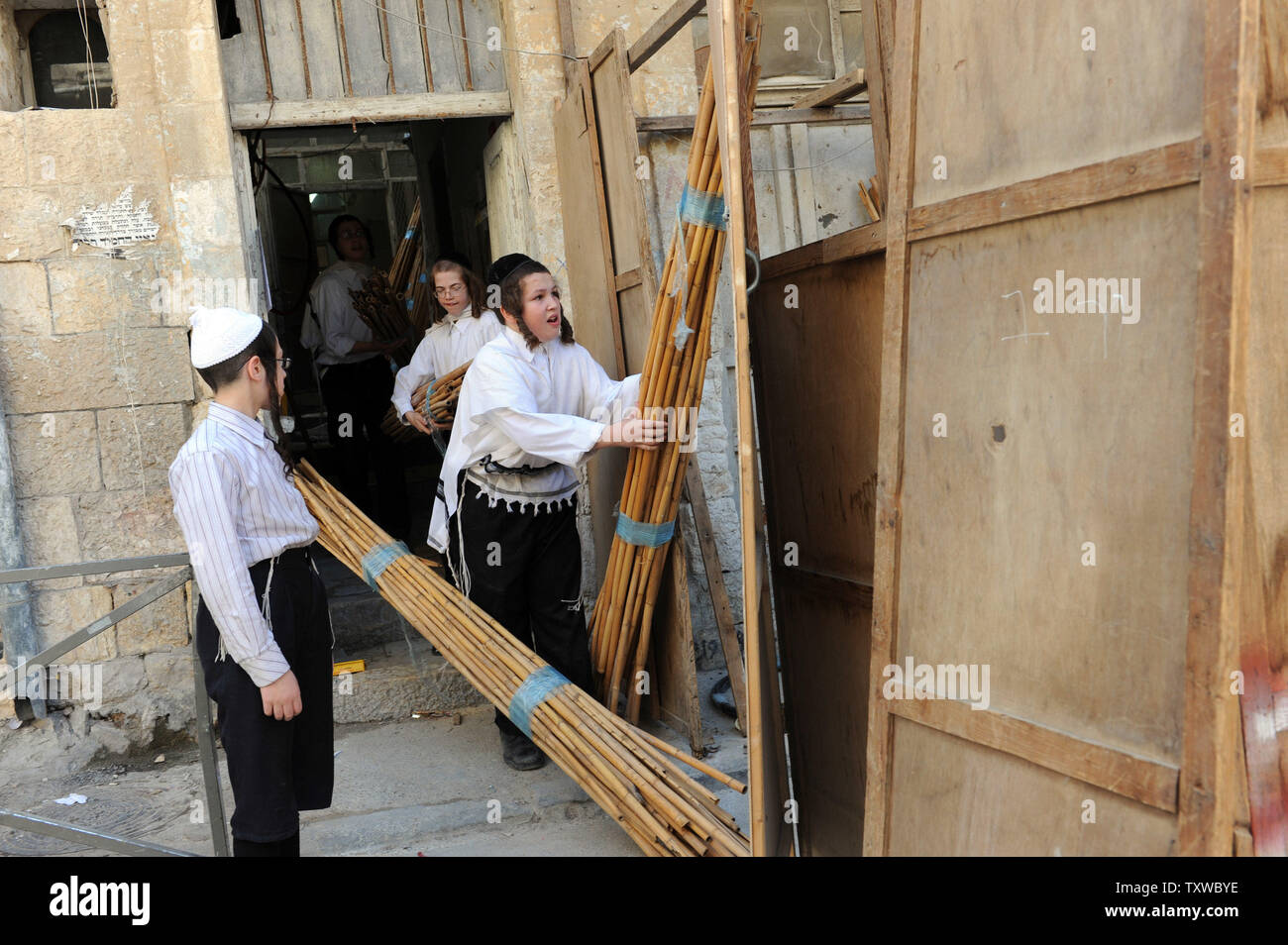 Ultra-Orthodox Jewish boys carry bamboo rods be used during the ...