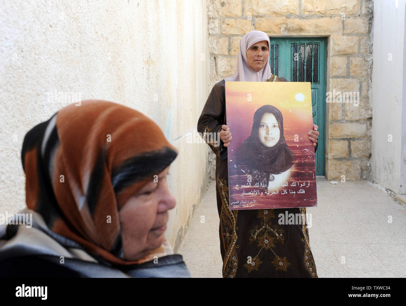 Eftikhar Tamimi holds a photo of her sister,Hamas terrorist, Ahlam ...
