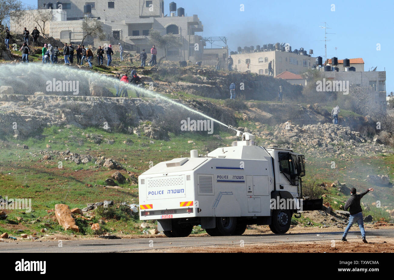 Israeli riot police spray skunk water at stone throwing Palestinians ...
