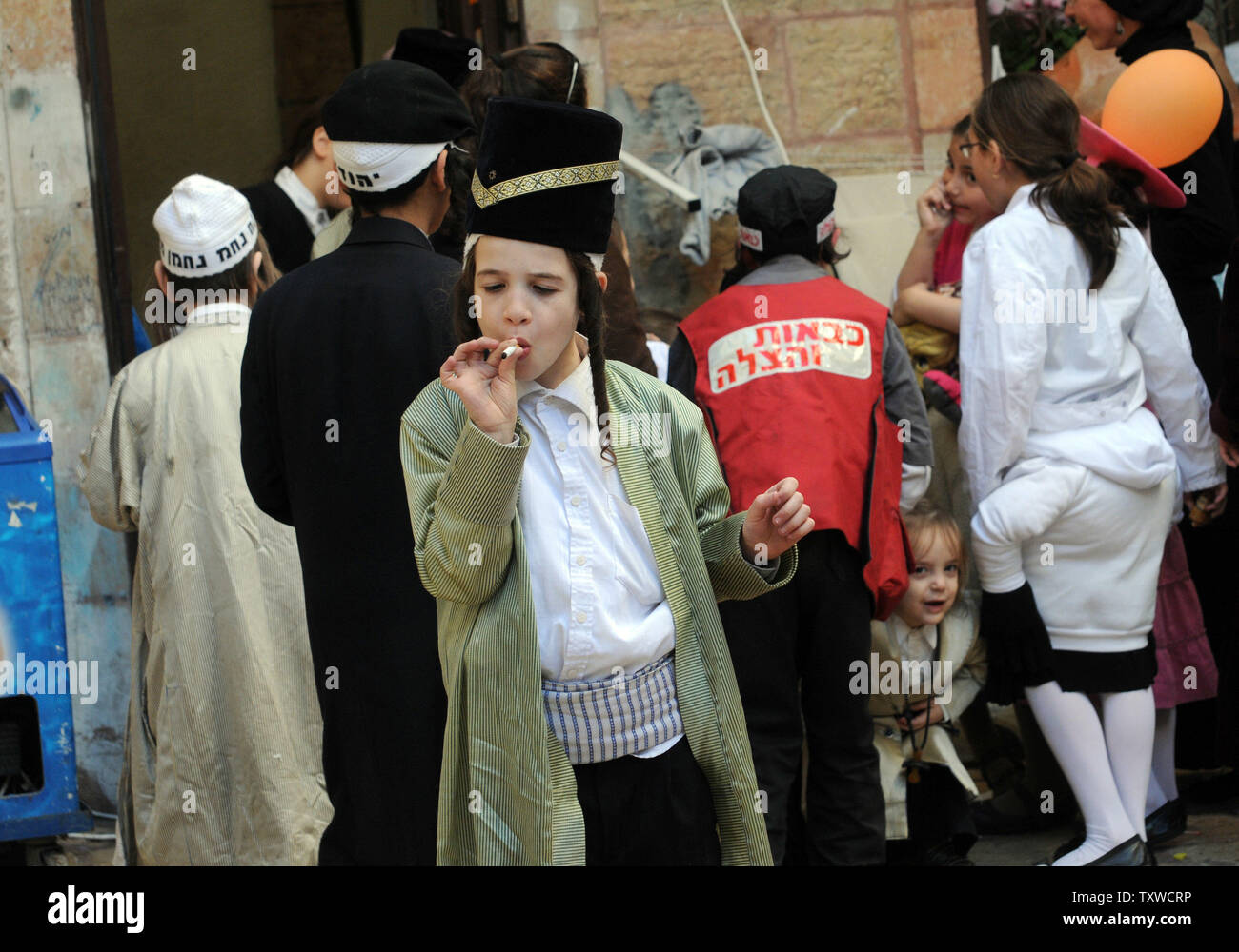 An Ultra-Orthodox Jewish boy smokes a cigarette on the Jewish holiday ...
